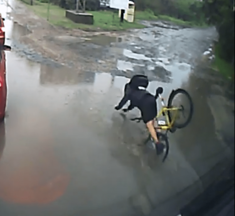Cyclist hits pothole on the road in Poland and lands in puddle in what ...