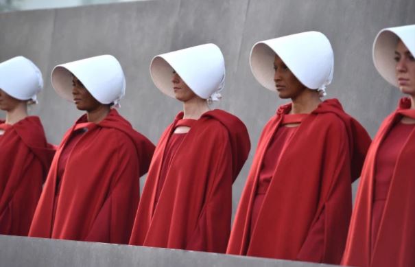 Melania Trump's red Christmas trees compared to women from The Handmaid ...